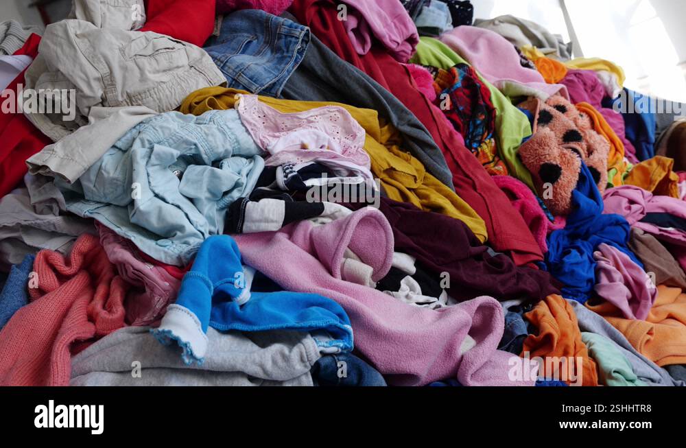 Textile Waste. A pile of old used clothes. Fast Fashion and Recycle ...