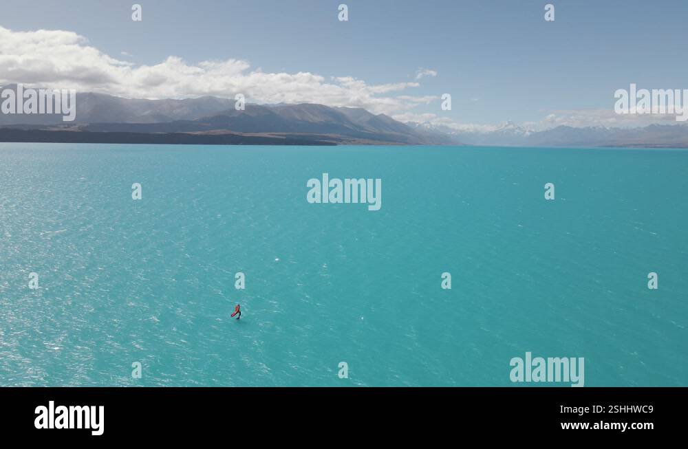 Wing foil surfing using hand-held sail on Lake Pukaki, South Island ...
