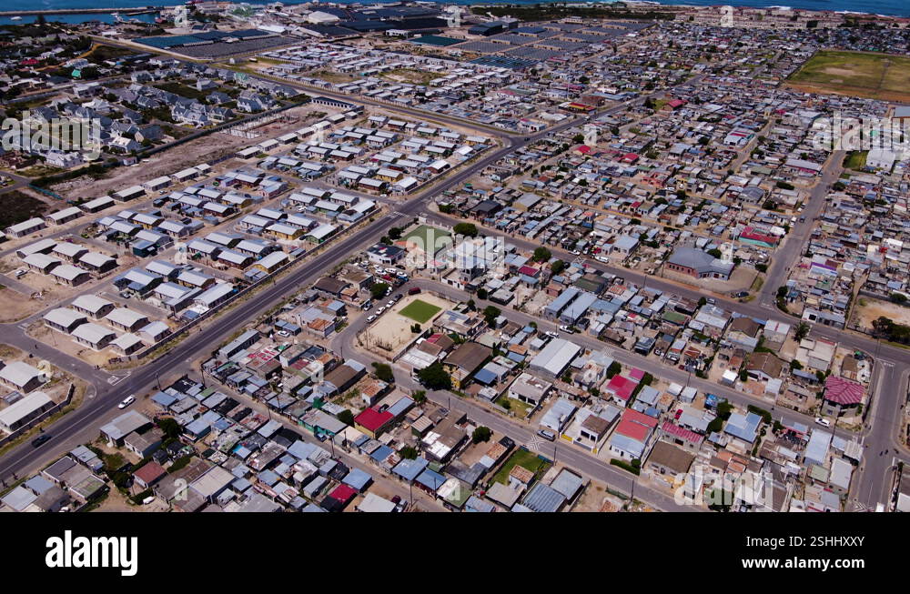 Vast coastal township in Hermanus - drone tilt-down view over Zwelihle ...