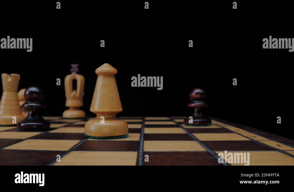 Chess game. A wooden chess pieces on a chess board in lights and ...