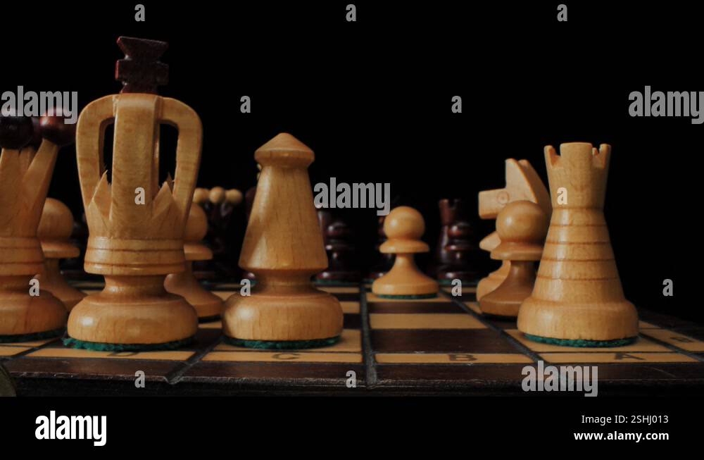 Chess game. A wooden chess pieces on a chess board in lights and ...