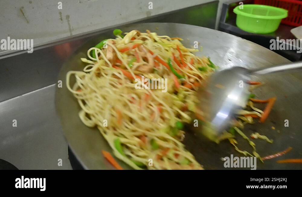 Ladle Being Used To Stir And Flip Vegetable Stir Fry Noodles In Wok ...