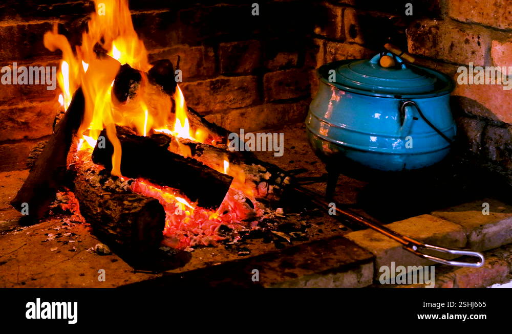 Traditional South African cooking in blue cast iron pot (potjie) - hot ...