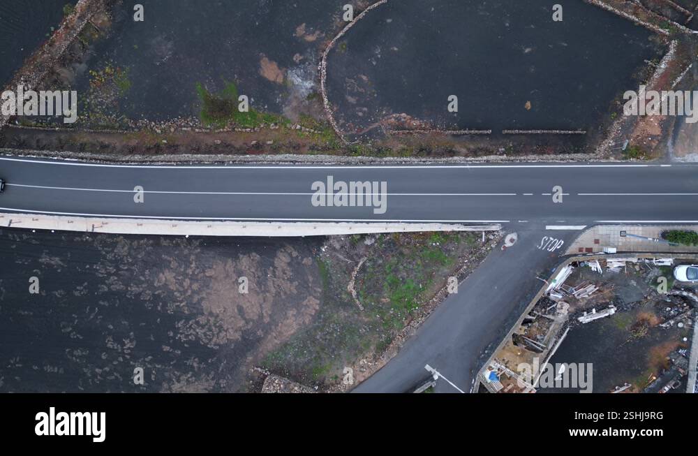 Cars driving on road through volcanic ash field. Great aerial view ...