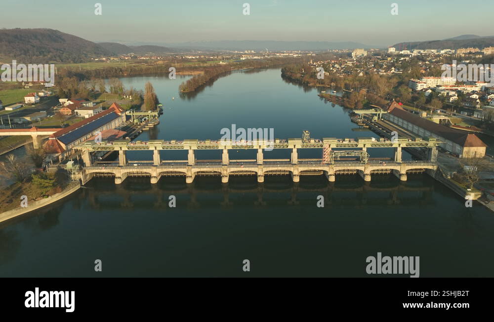 Person on a bicycle driving over the Hydro power plant over the Rhine ...