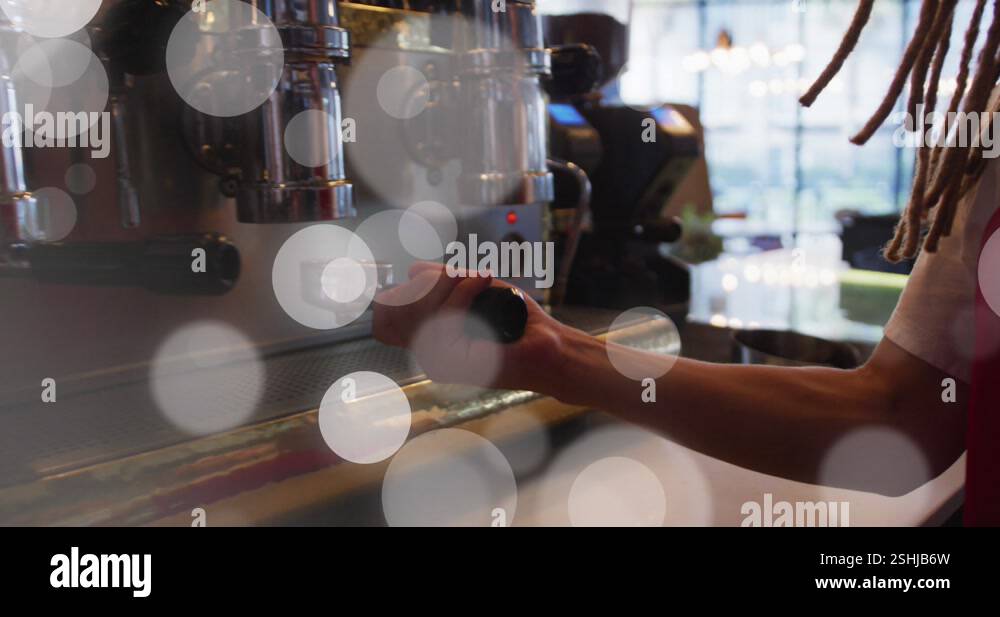 Animation of spots of light over man making coffee working in cafe ...