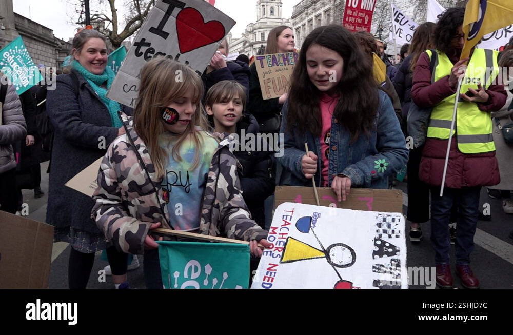 Three children holding placards join in chants on the National ...