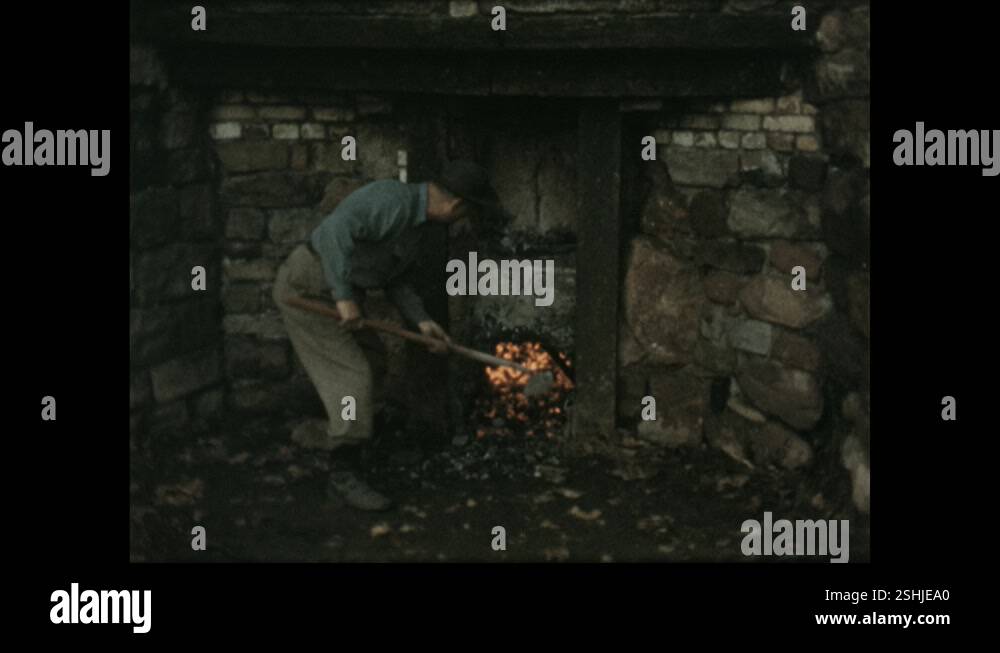 1940s: Man uses tool to rake coals in fireplace. Men move large rocks ...