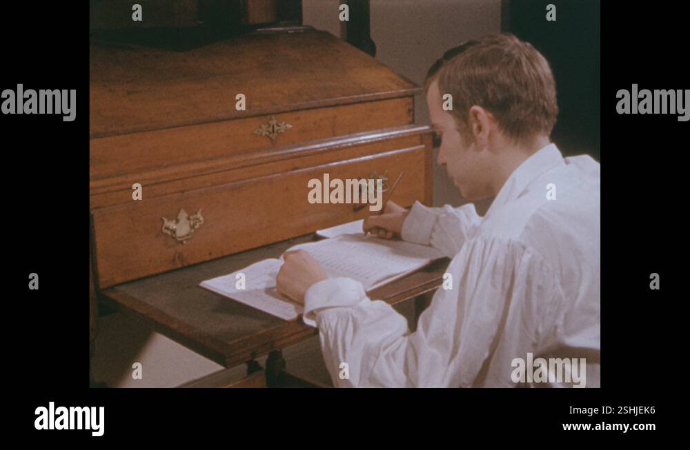 1800s: Man writing at desk. Writing in book. Man and woman in period ...