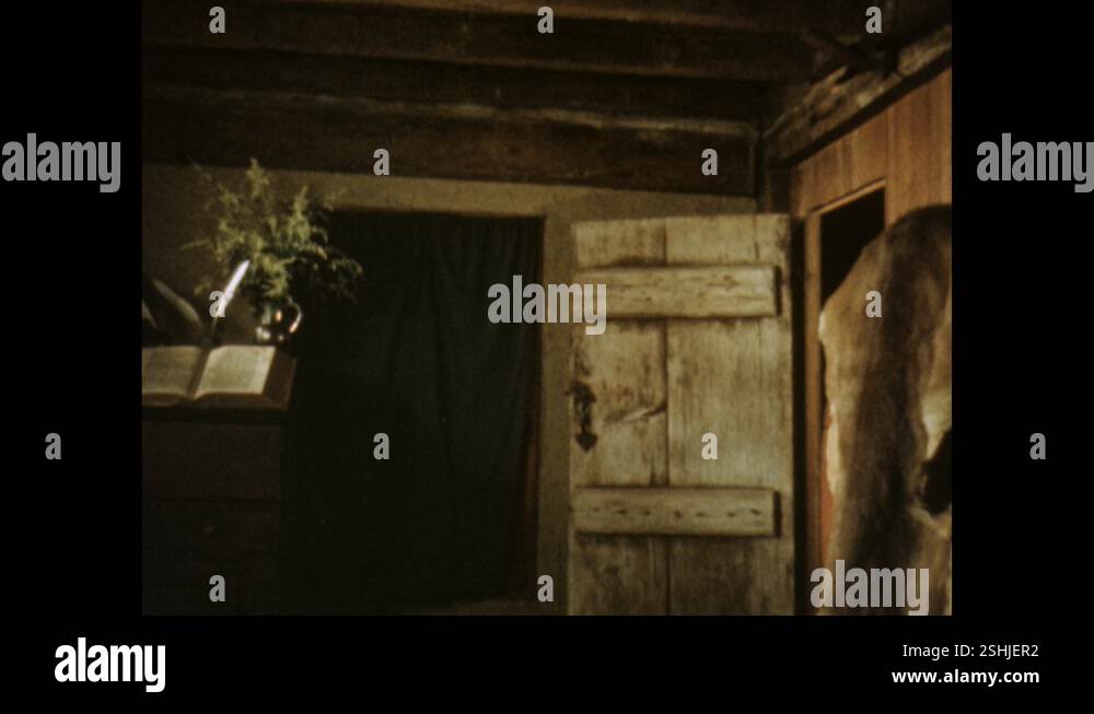 1940s: man in frontier clothes leaves wooden room, man and woman in ...