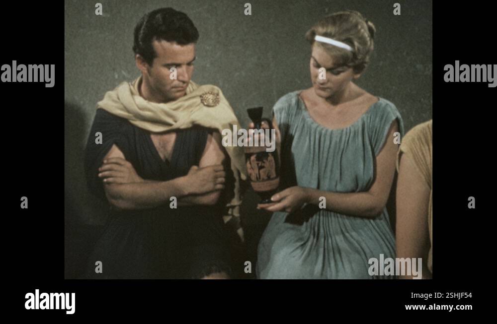 1950s: Man and woman look at decorative pitcher. Family sits Stock ...