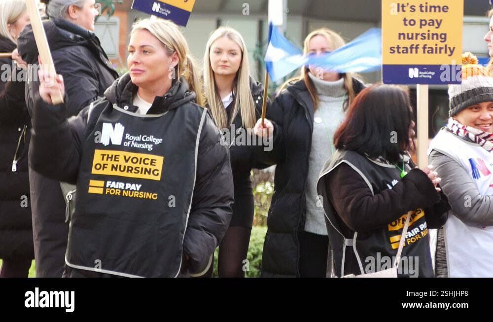 Overworked NHS workers protest on the picket line with banners and ...
