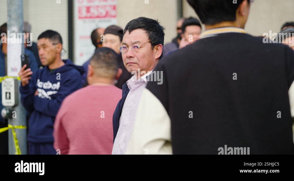 A Crowd of Asian People Watch and Film the Star Ballroom Crime Scene ...