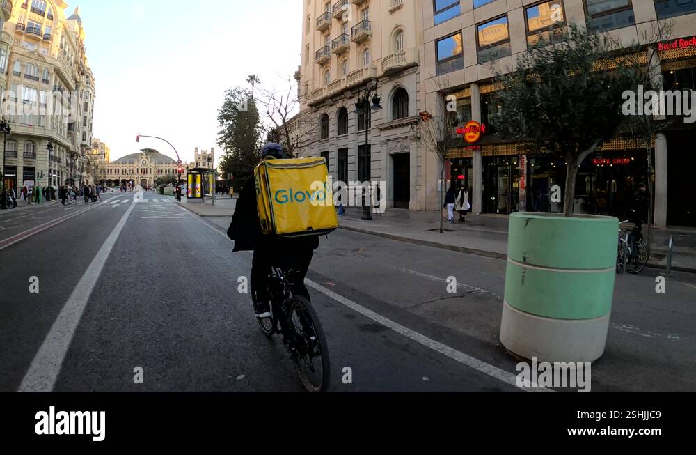 Glovo food delivery courier delivers food in Valencia, Spain - Follow bike Stock Video Footage ...