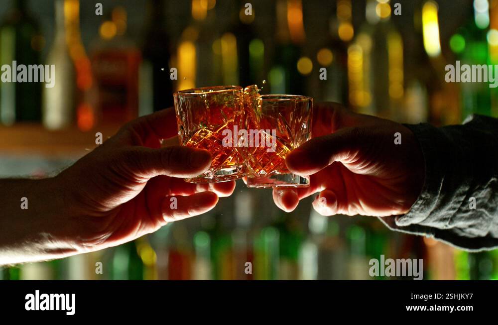 Super slow motion of cheering hard spirit drinks in bar Stock Video ...