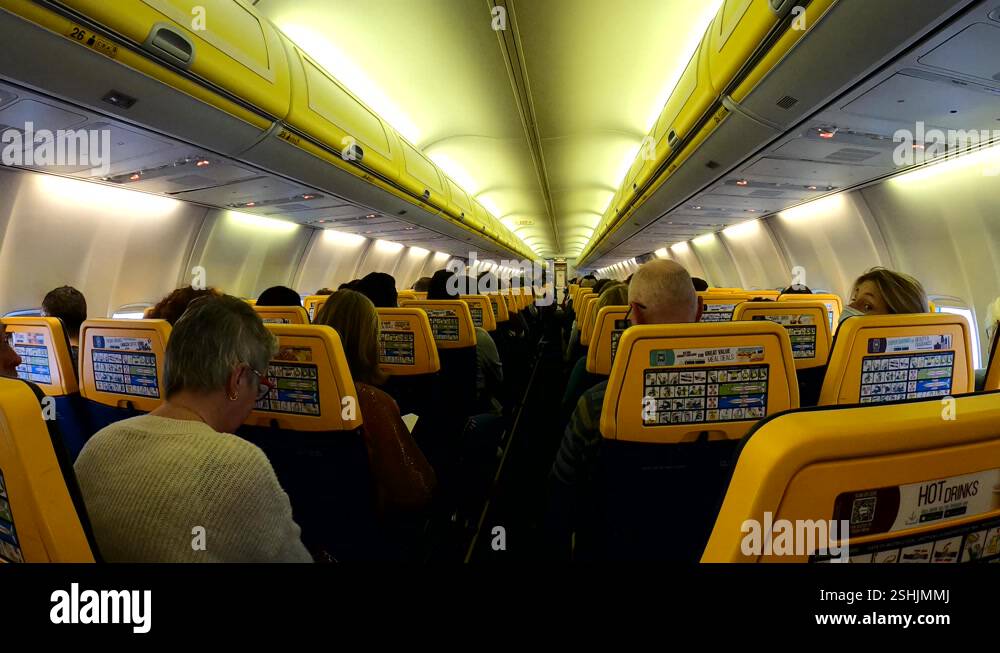 Airplane Passengers On Their Seats Inside The Plane Cabin. View From ...
