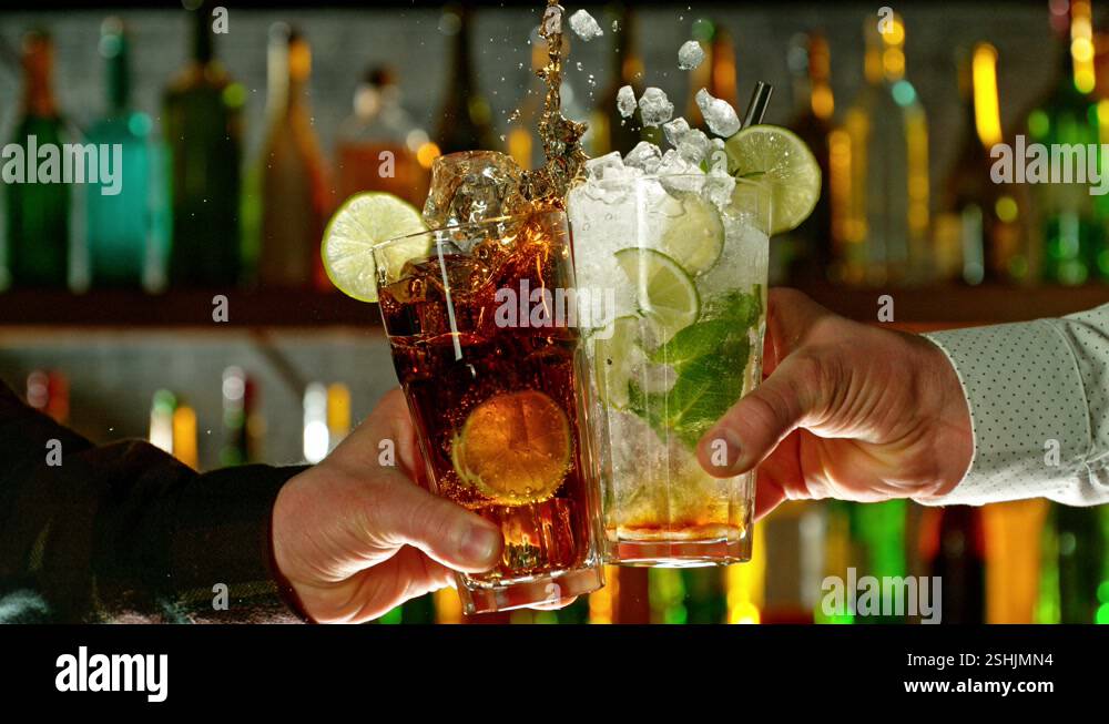 Super slow motion of cheering cocktail drinks in bar Stock Video ...