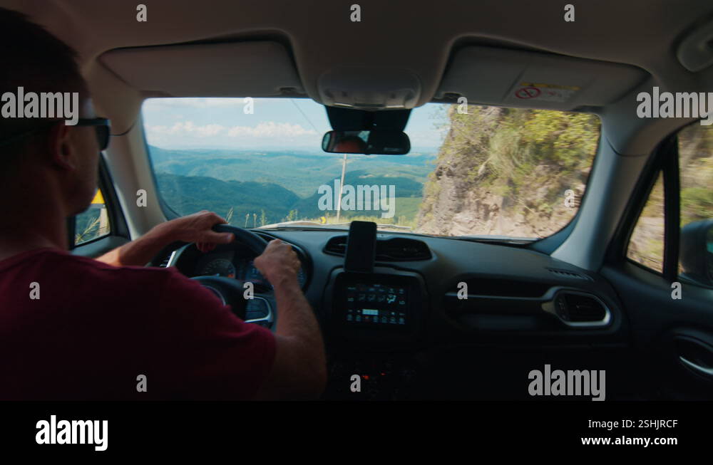 Driver steers the car on an extremely bumpy and narrow road in ...