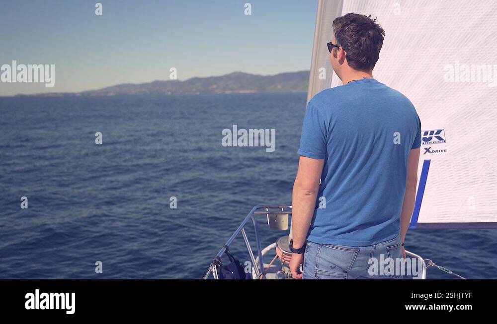 Man on sailing yacht boat ocean on a sunny day, travel adventure ...