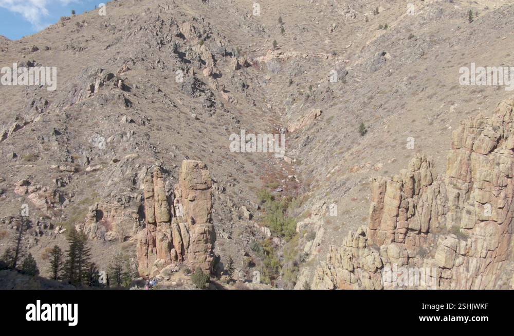 Establishing aerial view of a popular outdoor rock climbing spot in ...