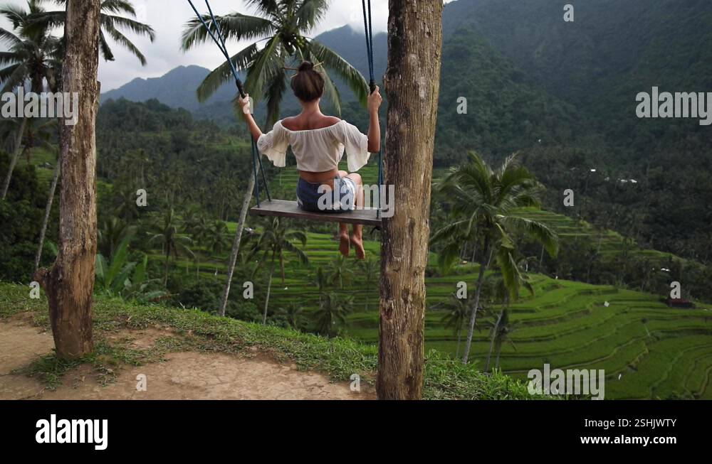 Woman on rope swings with beautiful view on rice terraces in the Bali ...