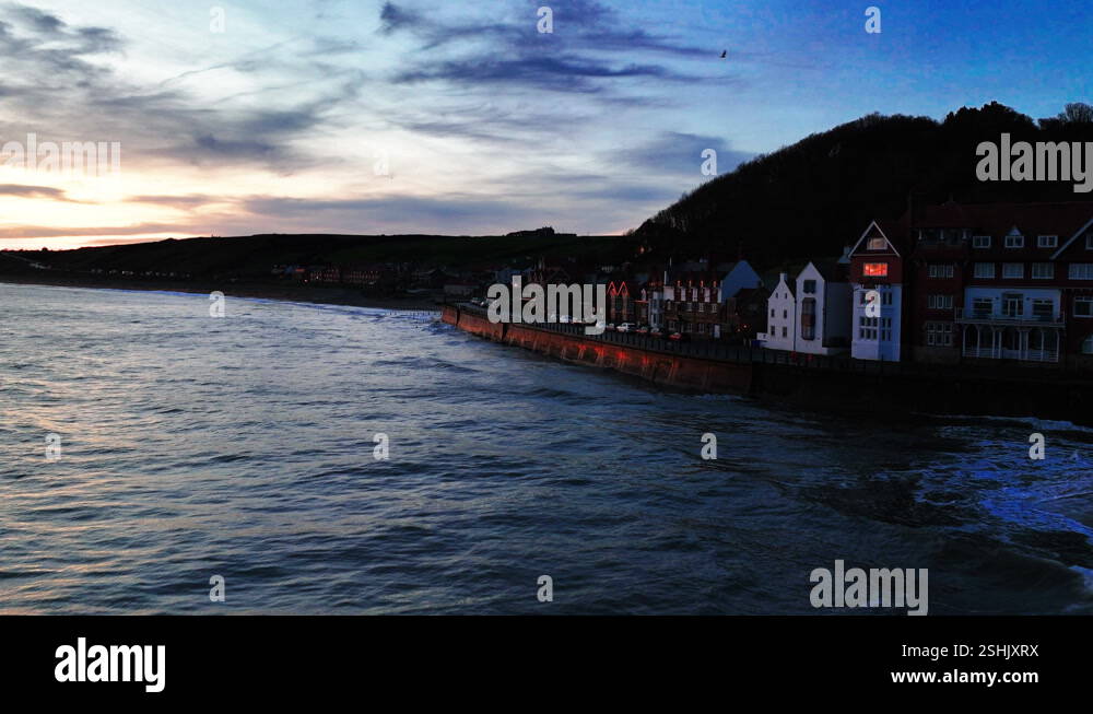 Sandsend sea front, near whitby, drone move along sea wall with waves ...