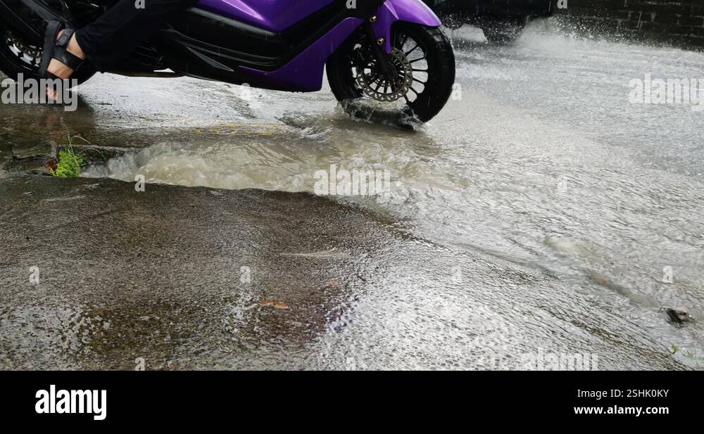 After severe rain, road flooded with water running out from clogged ...
