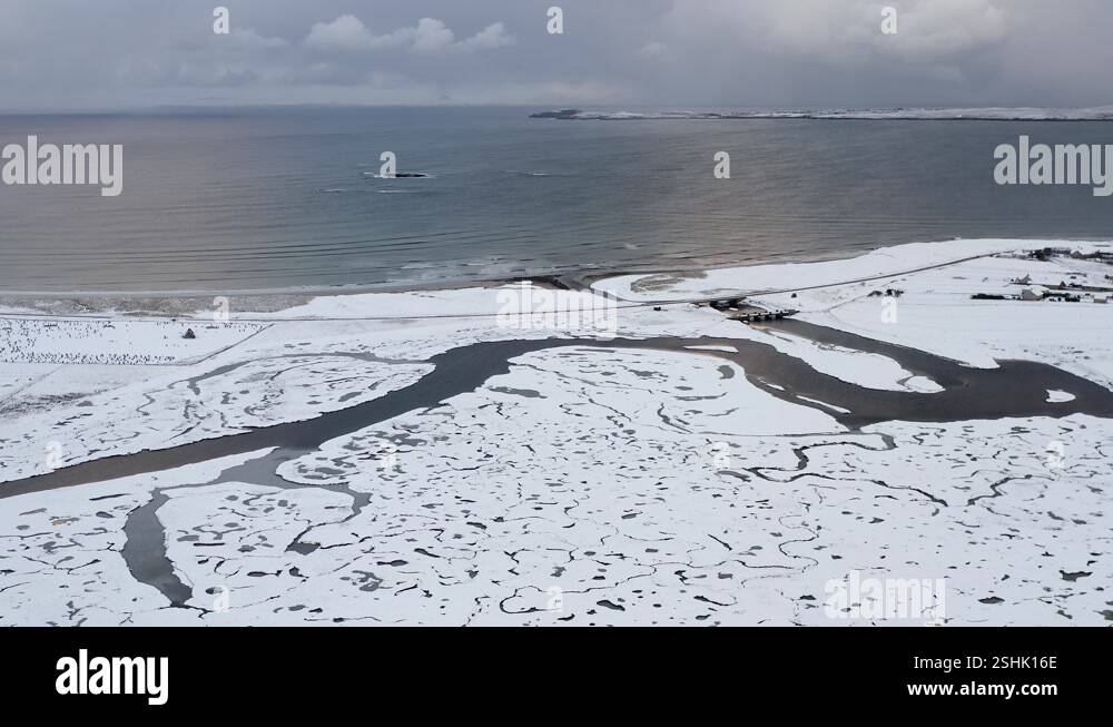 Dynamic drone shot of the snowy Gress river with Gress beach and Point ...