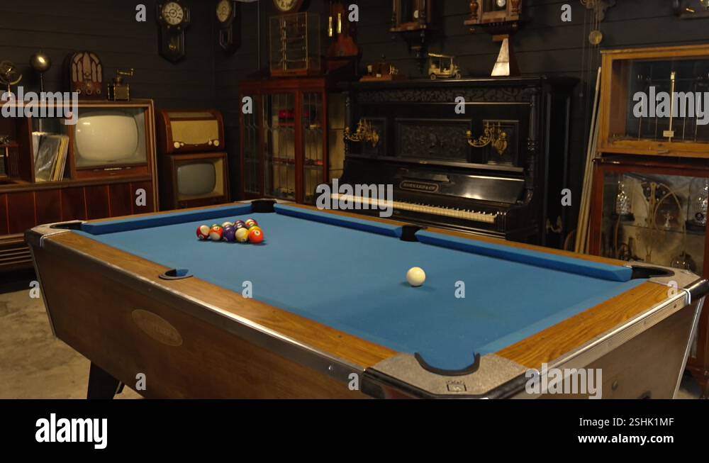 Vintage game room with television piano pool table tilt shot Stock ...