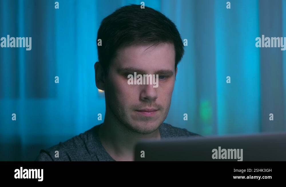 Man working on laptop at night Stock Video Footage - Alamy