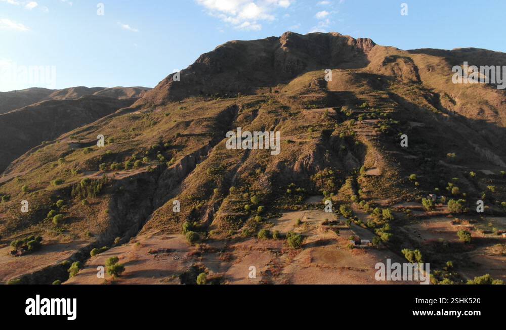 Wide aerial of rural farms and crops on steep mountain in Bolivia high ...