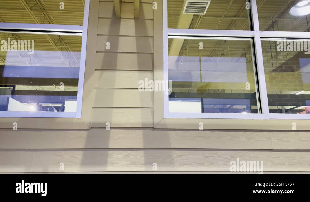 Exterior retail strip mall panel walls and windows reflections inside ...