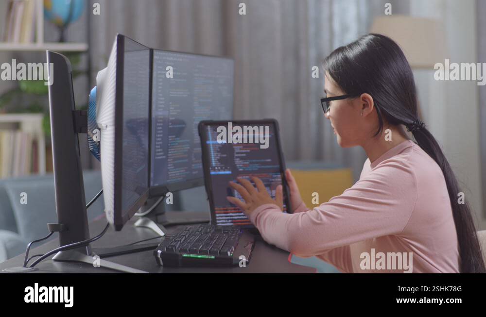 Asian Teen Girl Programmer Looking At Database On Tablet While Creating ...