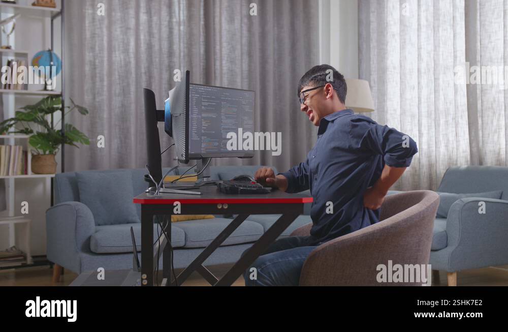 Asian Boy Programmer Having A Backache While Creating Software Engineer Stock Video Footage - Alamy