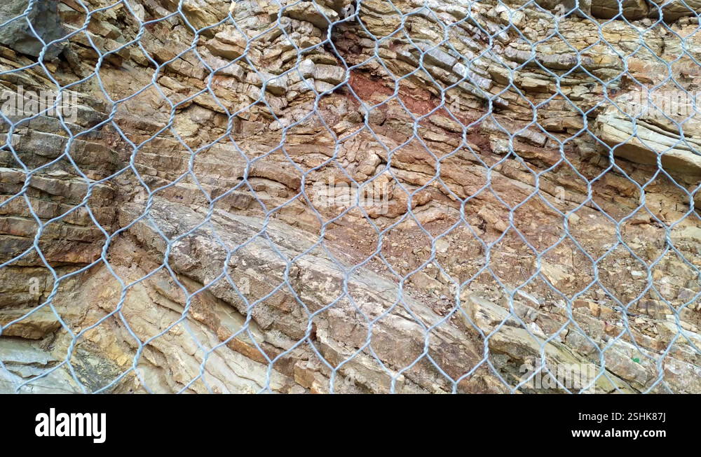 Wire mesh metal net protection against falling rocks. Metal net on a ...