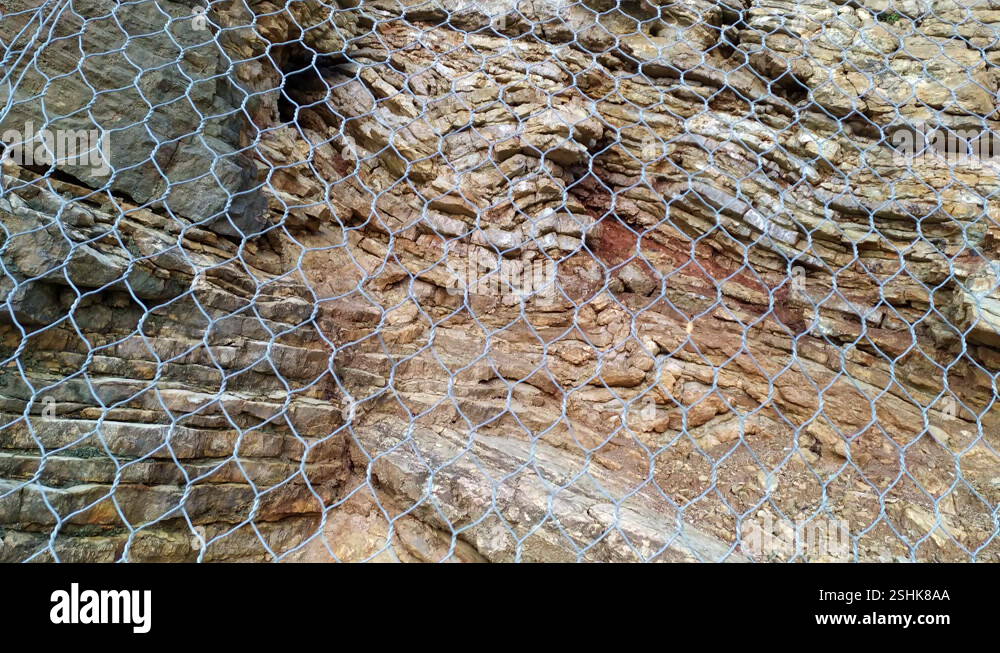 Wire mesh metal net protection against falling rocks. Metal net on a ...