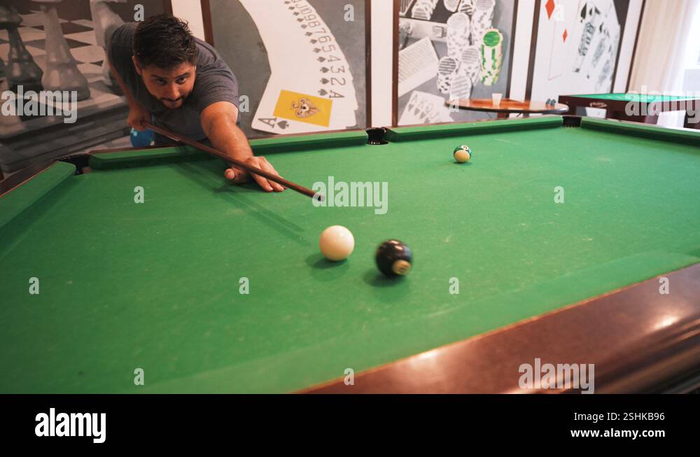 Casual player pocketing the 8 ball winning the american style eight ...