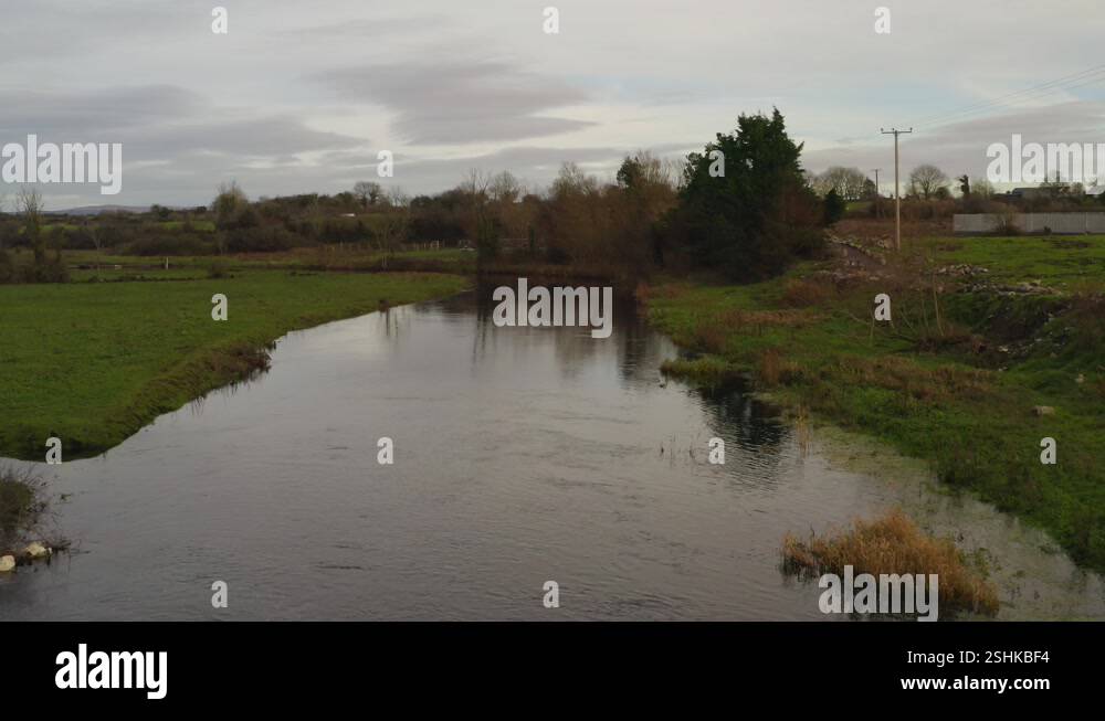 Aerial view flying over the Gort river on a cloudy evening Stock Video ...