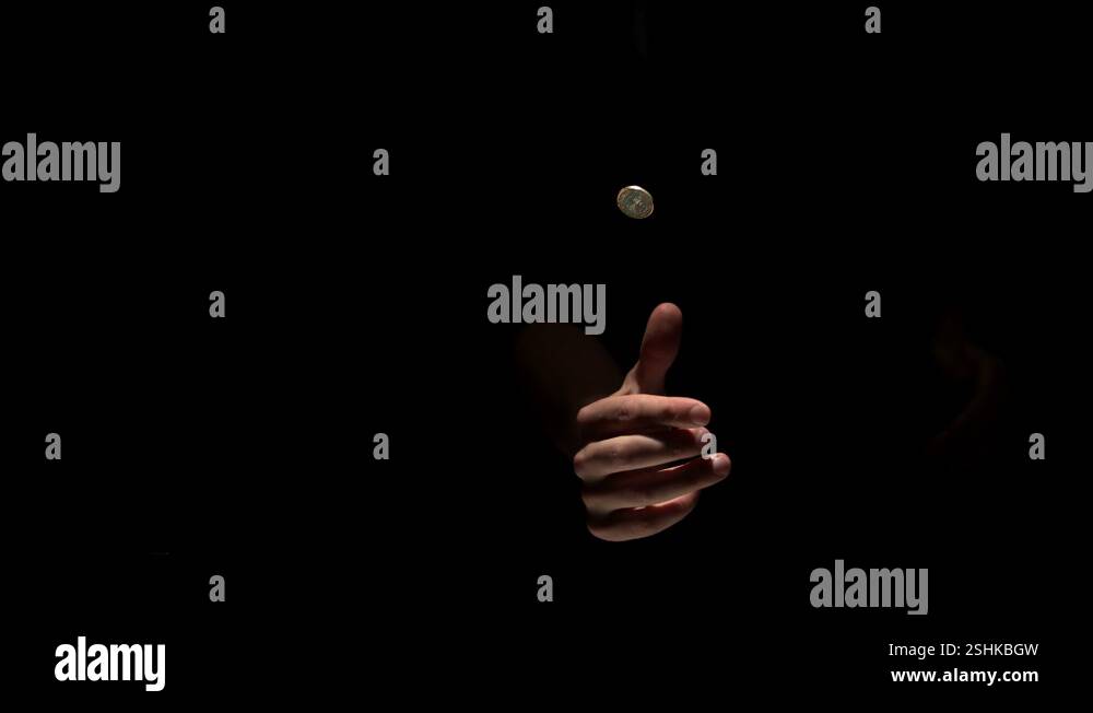 Hand flipping a euro coin on black background Stock Video Footage - Alamy