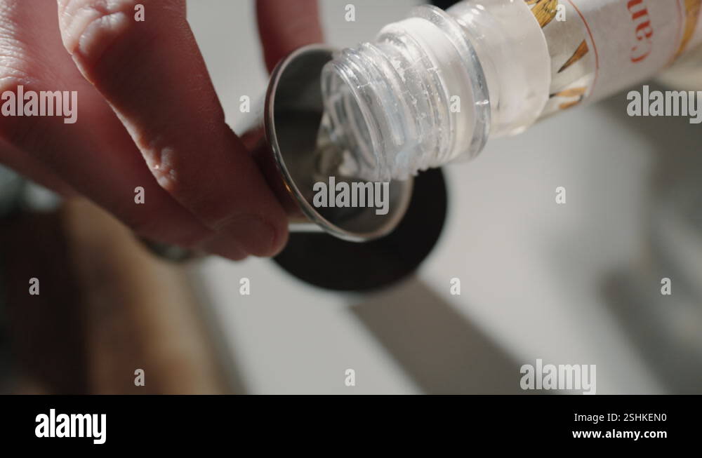 Pouring simple syrup into jigger and into cocktail shaker Close Up Top ...