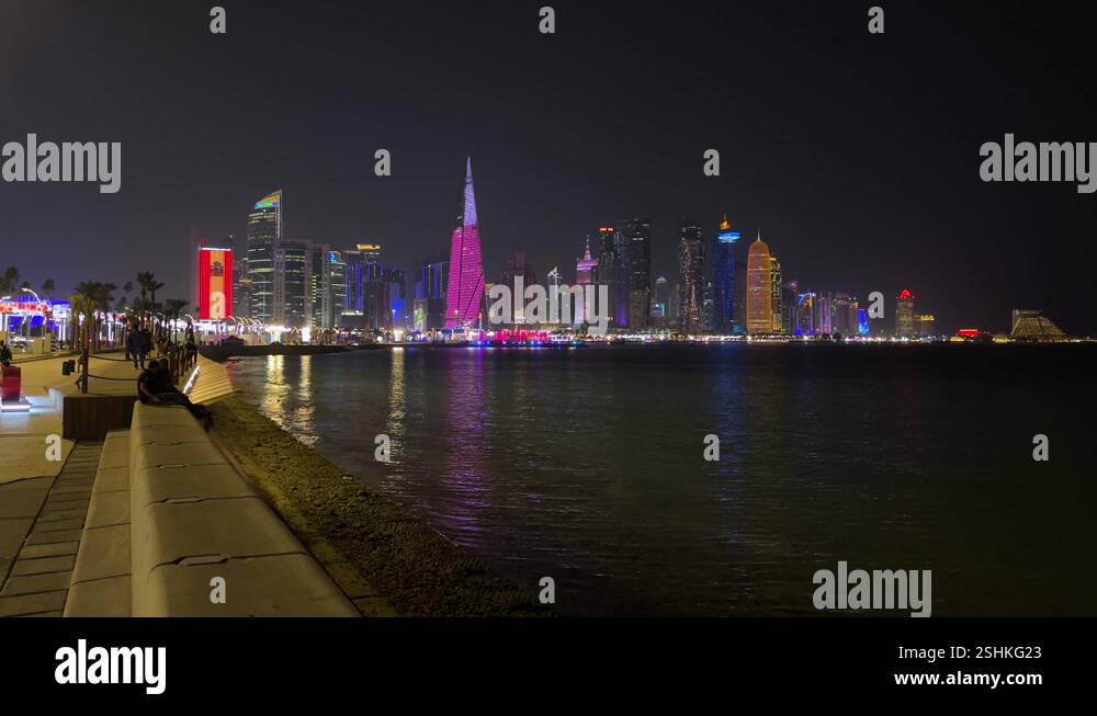 Doha beach at night reflect the beautiful Corniche sea city downtown ...