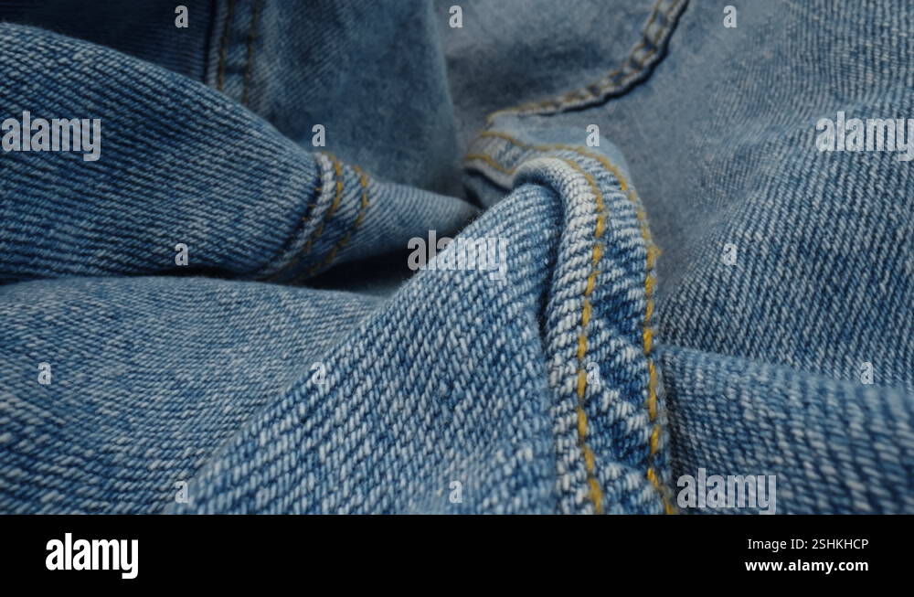 Macro blue denim jeans material. Slider dolly close-up clothing fabric ...