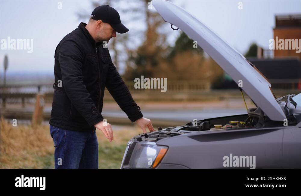 Sad disappointed man on broken car accident. Vehicle check engine with ...