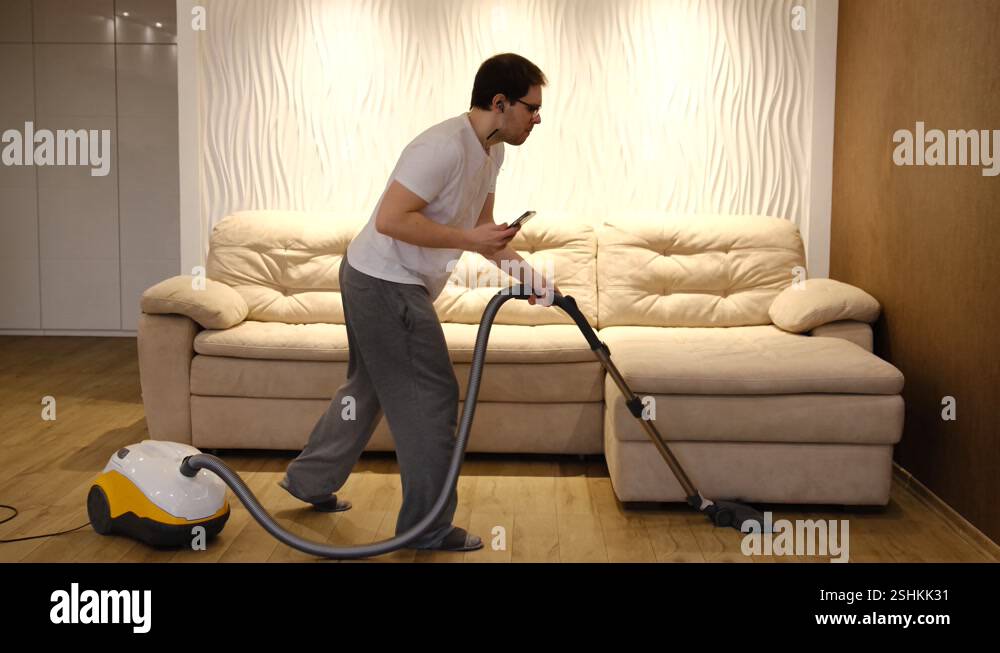 Young caucasian man dancing with vacuum cleaner Stock Video Footage - Alamy