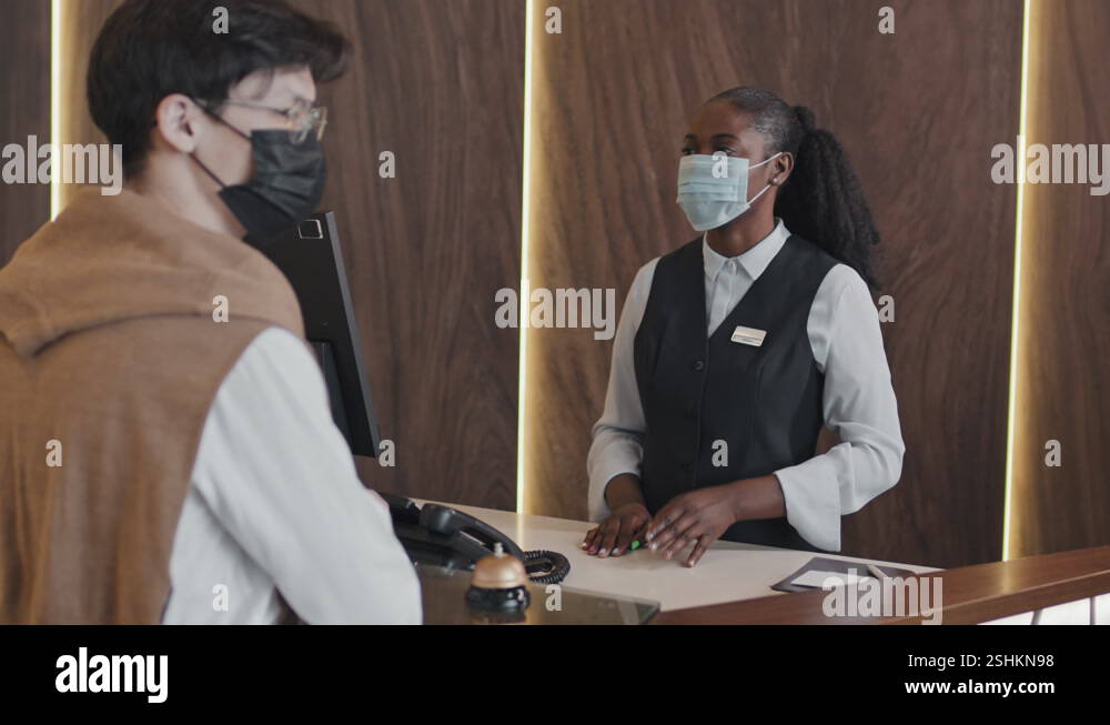 Receptionist Wearing Mask Working With Hotel Guest Stock Video Footage ...