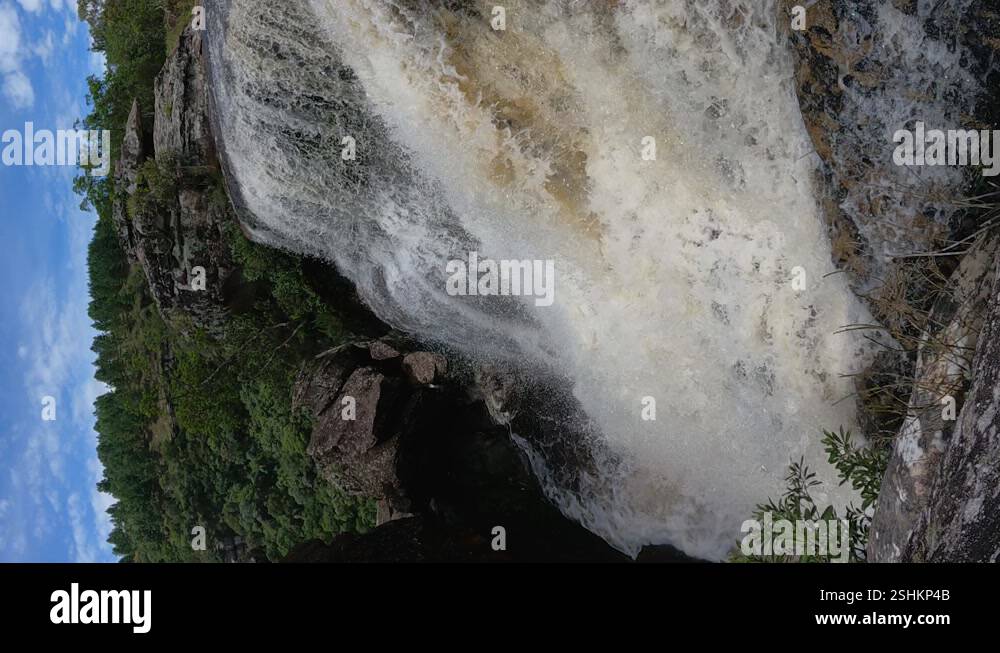 Slow motion video of a waterfall with a huge volume of water, vertical ...