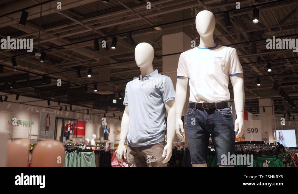 white mannequins in clothes in a large shopping mall in a fashion store ...