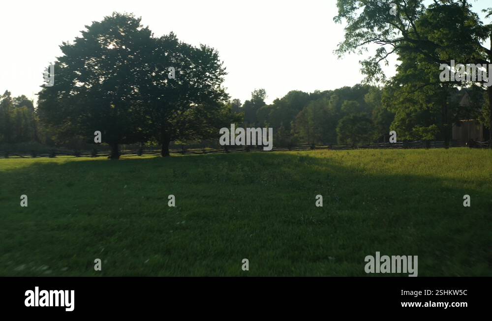 drone shot over the fence into the Joseph Smith family farm, frame ...