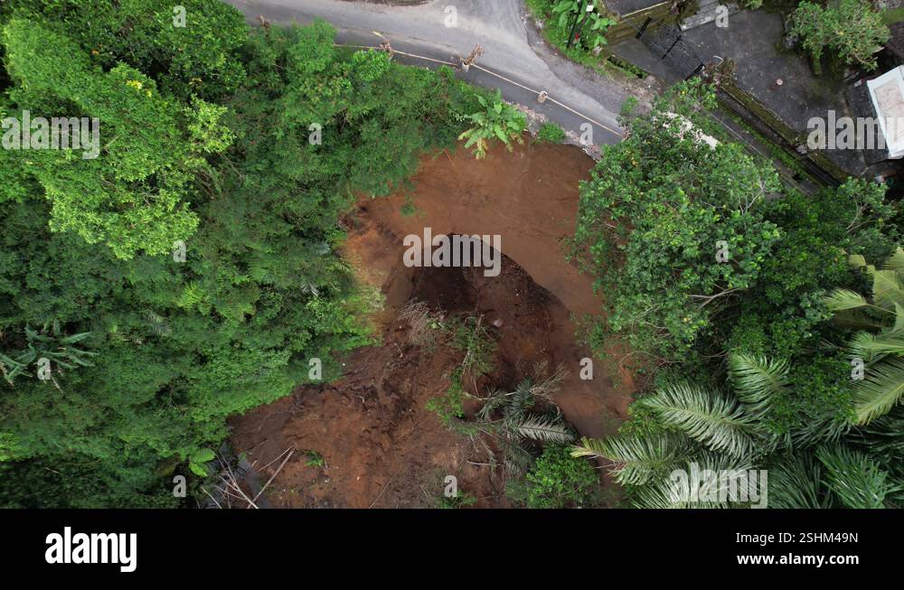 Dangerous collapse of steep slope destroyed half road, aerial view of ...