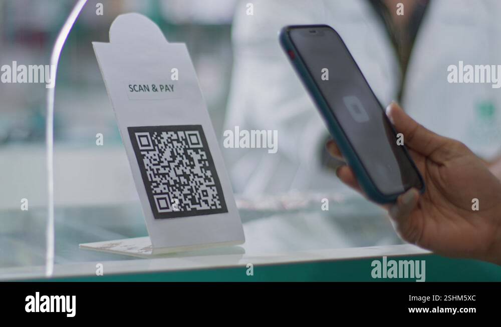 Customer scanning a barcode to pay e-money online in a general or ...